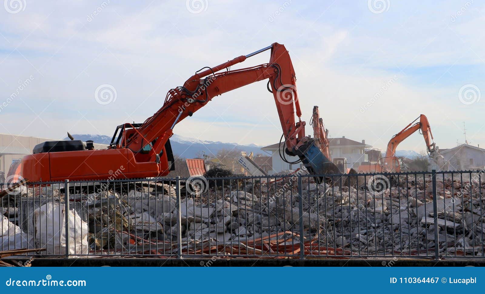 Excavators at Work, between Rubble and Dust, for an Urban Redevelopment ...