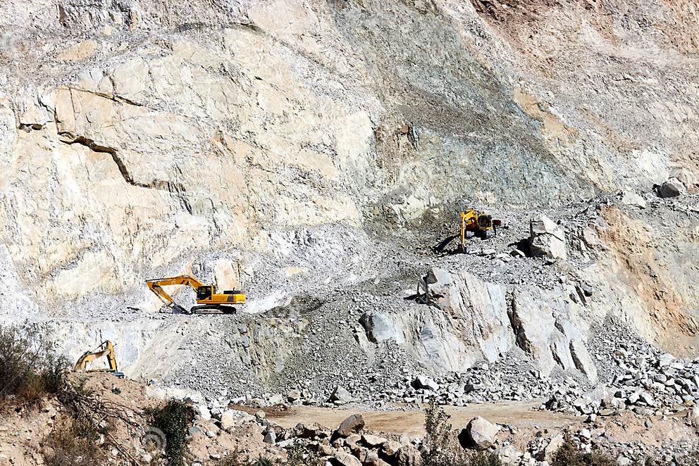 Excavators Working on the Slope of the Cliff Stock Image - Image of ...