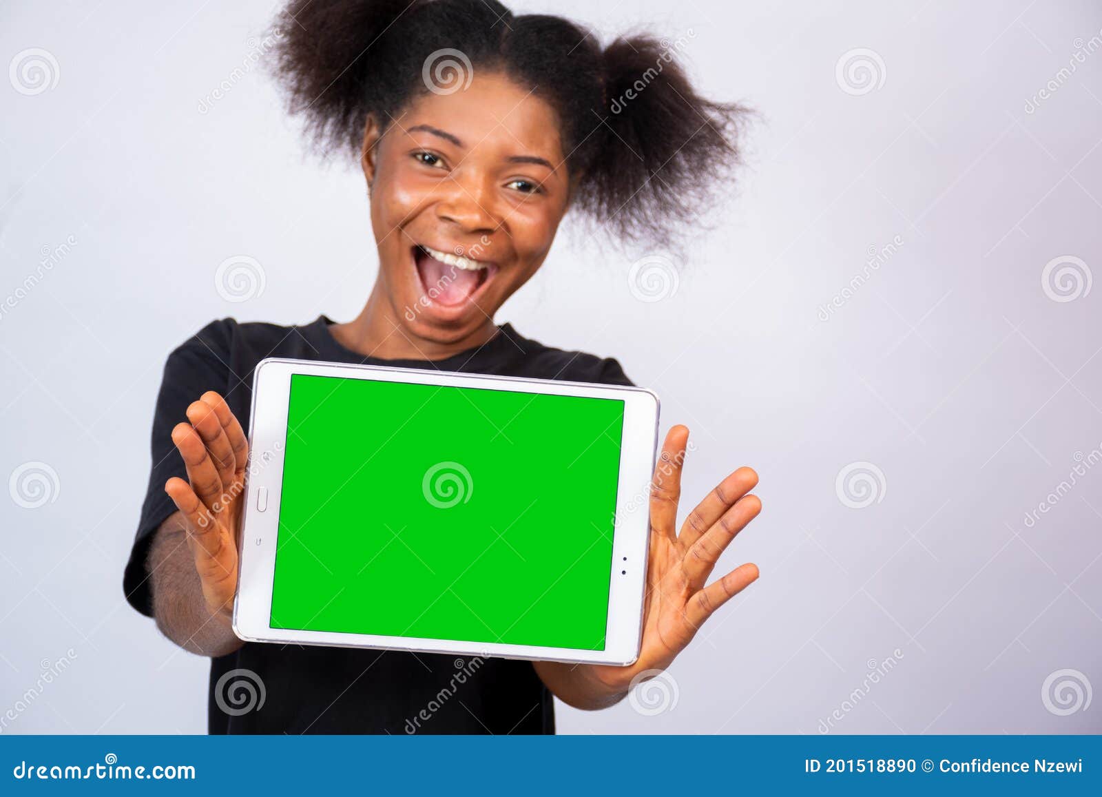 Excited African Lady Holding a Tablet Computer with the Screen Facing ...