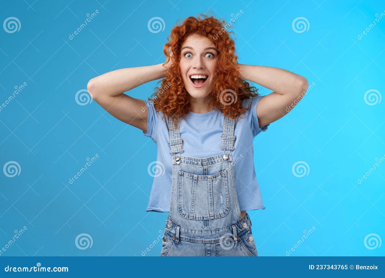 Excited Amused Joyful Redhead Curly Girl Having Amazing Perfect News