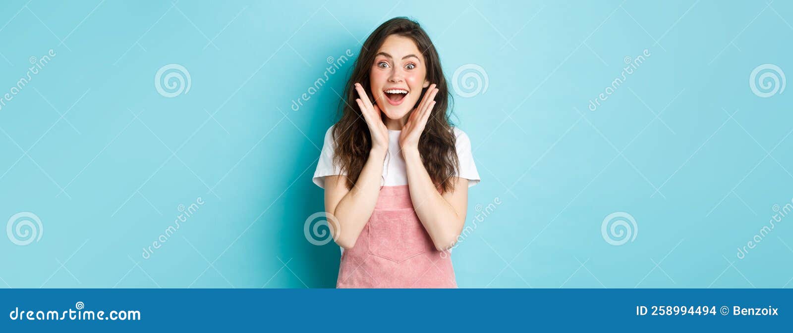 Excited Brunette Woman With Cute Curly Hairstyle Gasping Amazed And