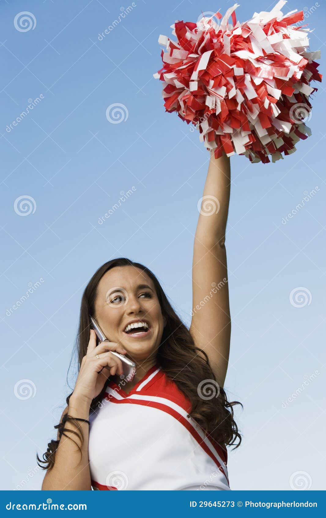 Excited Cheerleader Using Cell Phone Stock Image - Image of person ...
