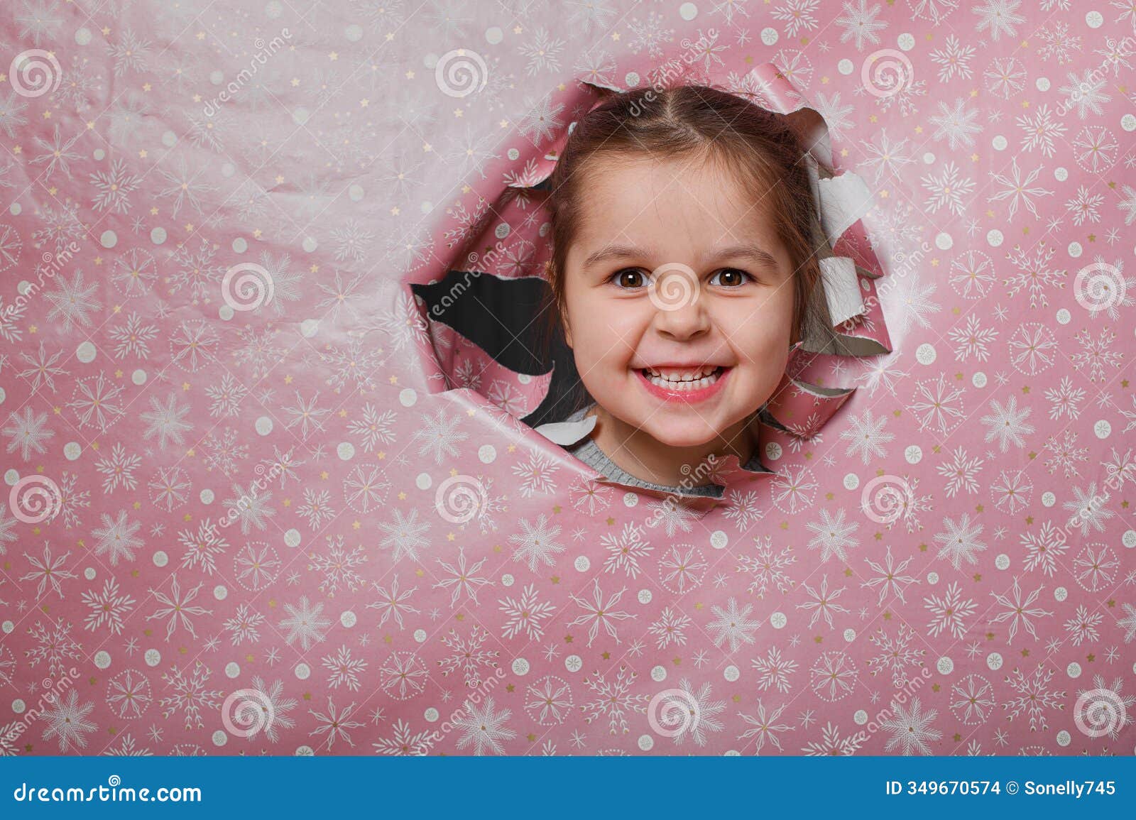 Excited Child Peeking through Wrapping Paper Stock Photo - Image of ...