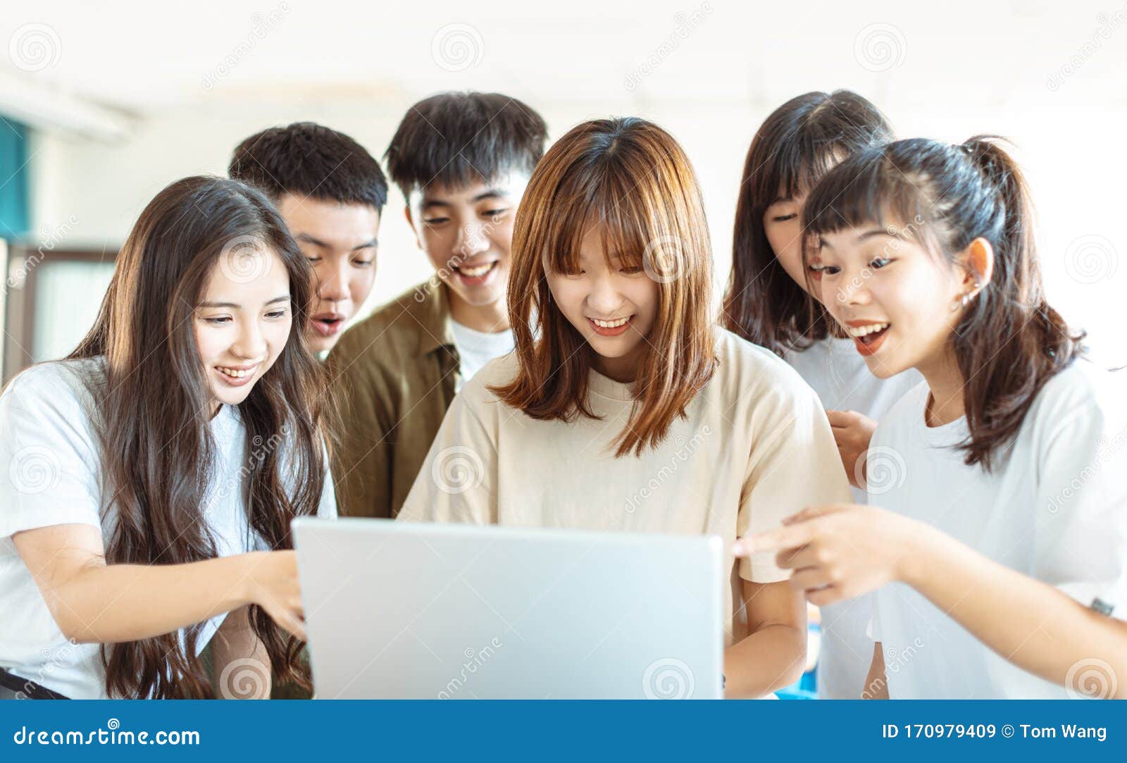 Excited College Students Looking at Laptop in Classroom Stock Image ...