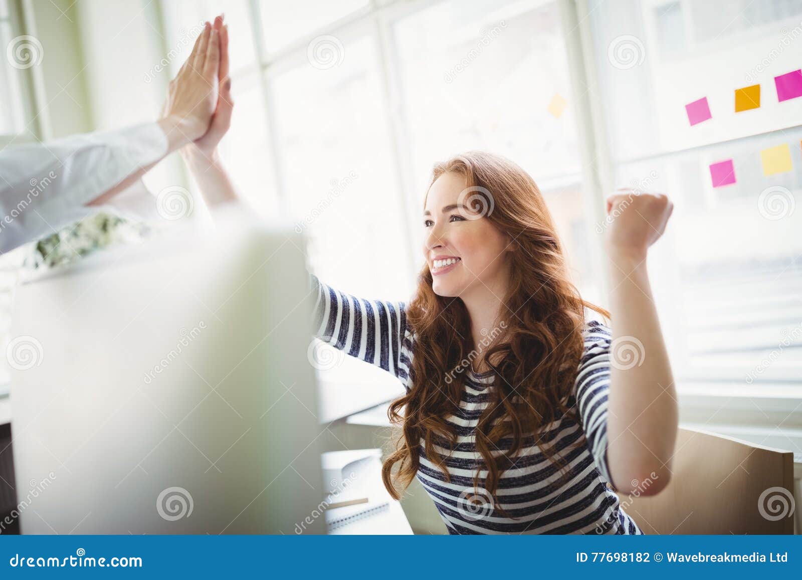 Excited Coworkers Giving High-five at Creative Office Stock Photo ...