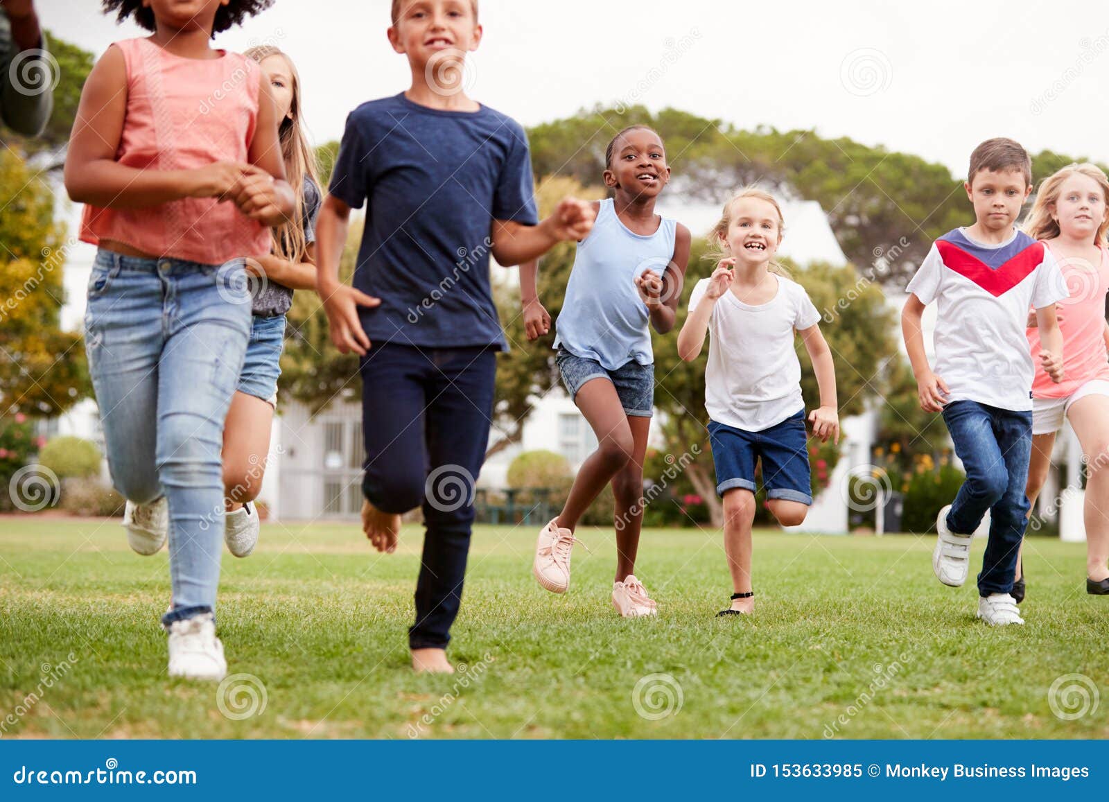 Excited Elementary School Pupils Running Across Field at Break Time ...
