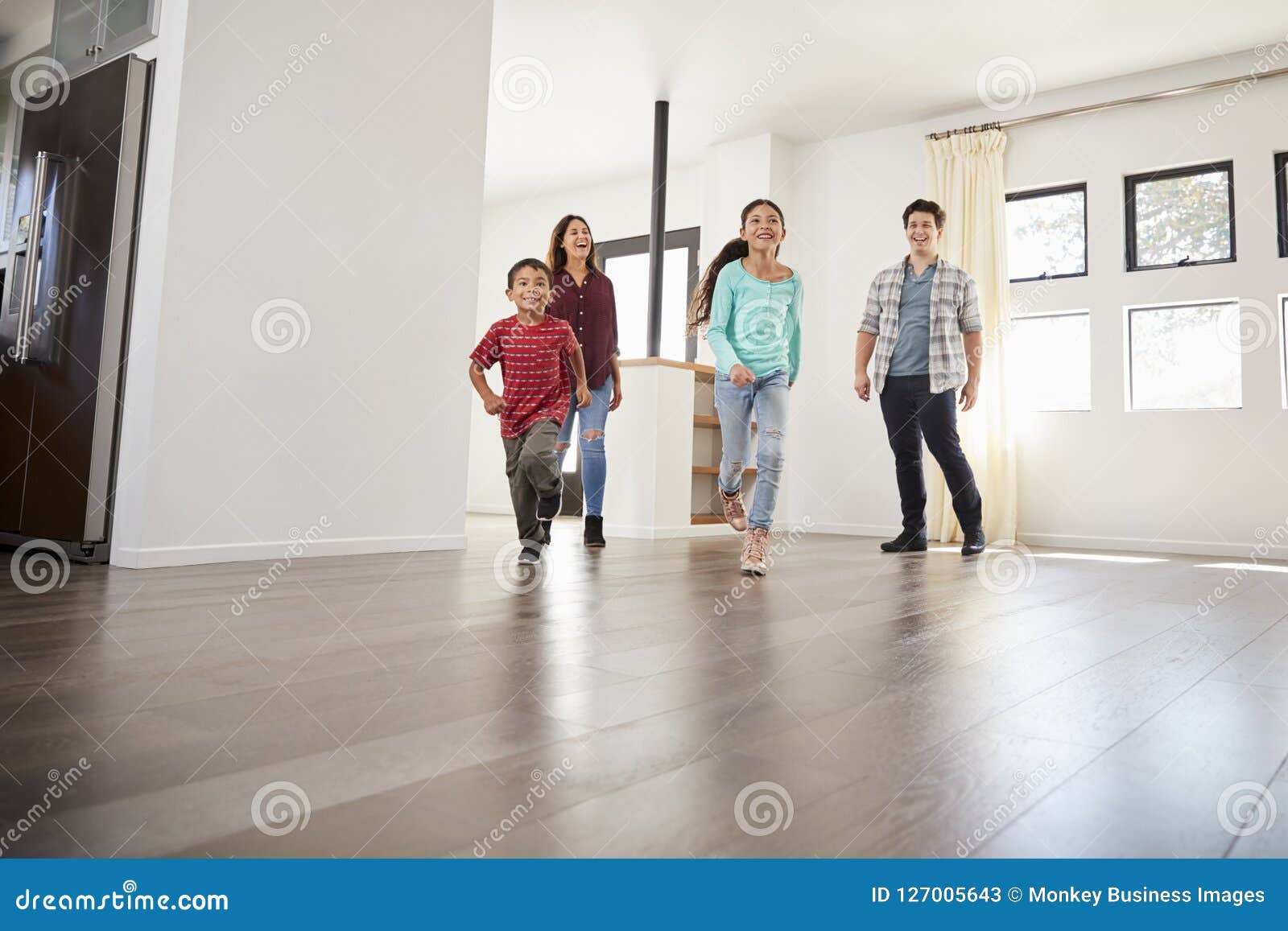 Excited Family Exploring New Home on Moving Day Stock Image - Image of ...