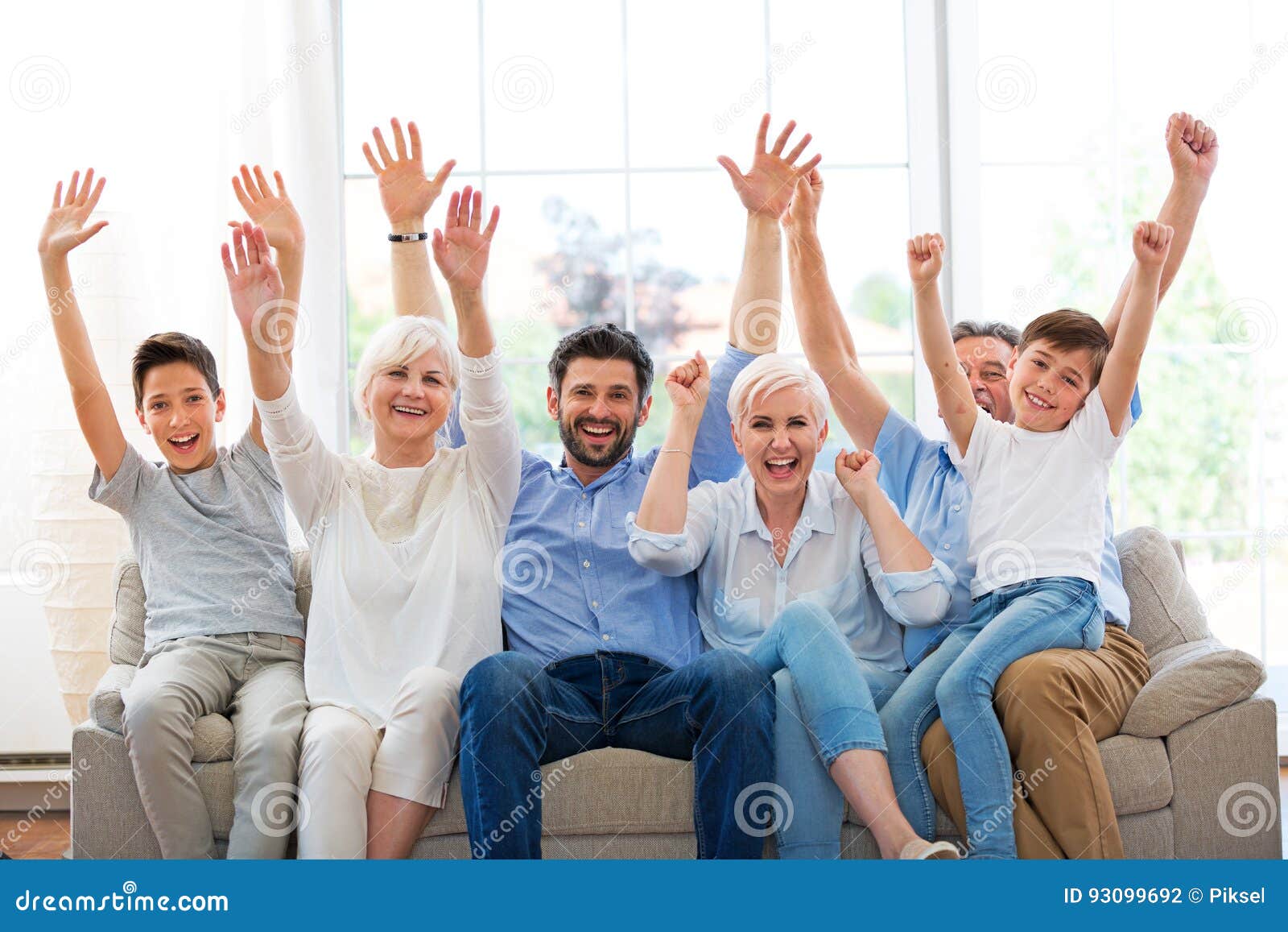 Excited family on sofa stock photo. Image of family, clenching - 93099692