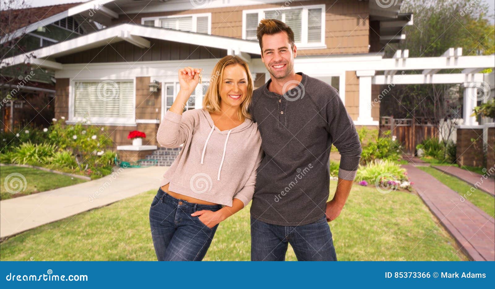 Excited First Time Homebuyers Standing in Front of Their New Home Stock ...