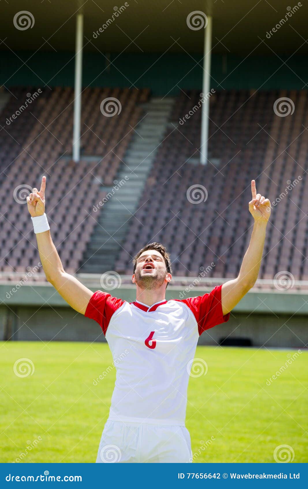 Excited Football Player with Hands Raised Stock Photo - Image of ...