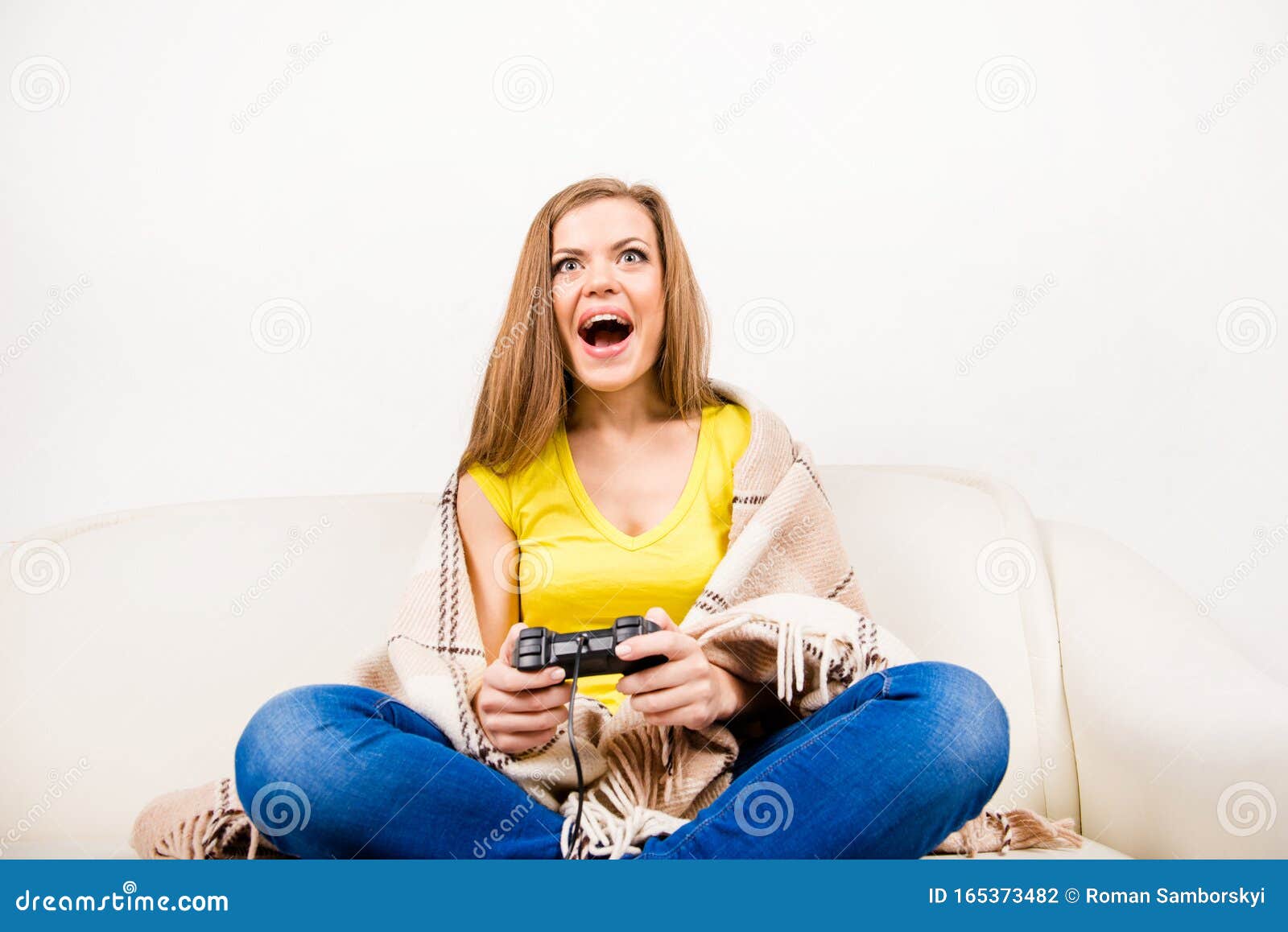 Excited Girl Playing with Game Console on Sofa Stock Photo - Image of ...