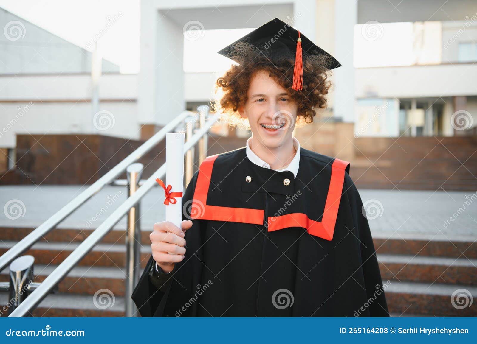 Excited Graduate Student in Gown with Risen Hands Holding Diploma ...