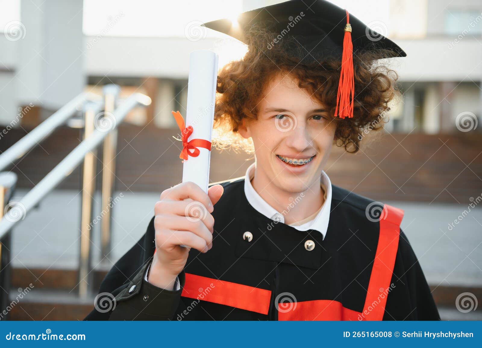 Excited Graduate Student in Gown with Risen Hands Holding Diploma ...