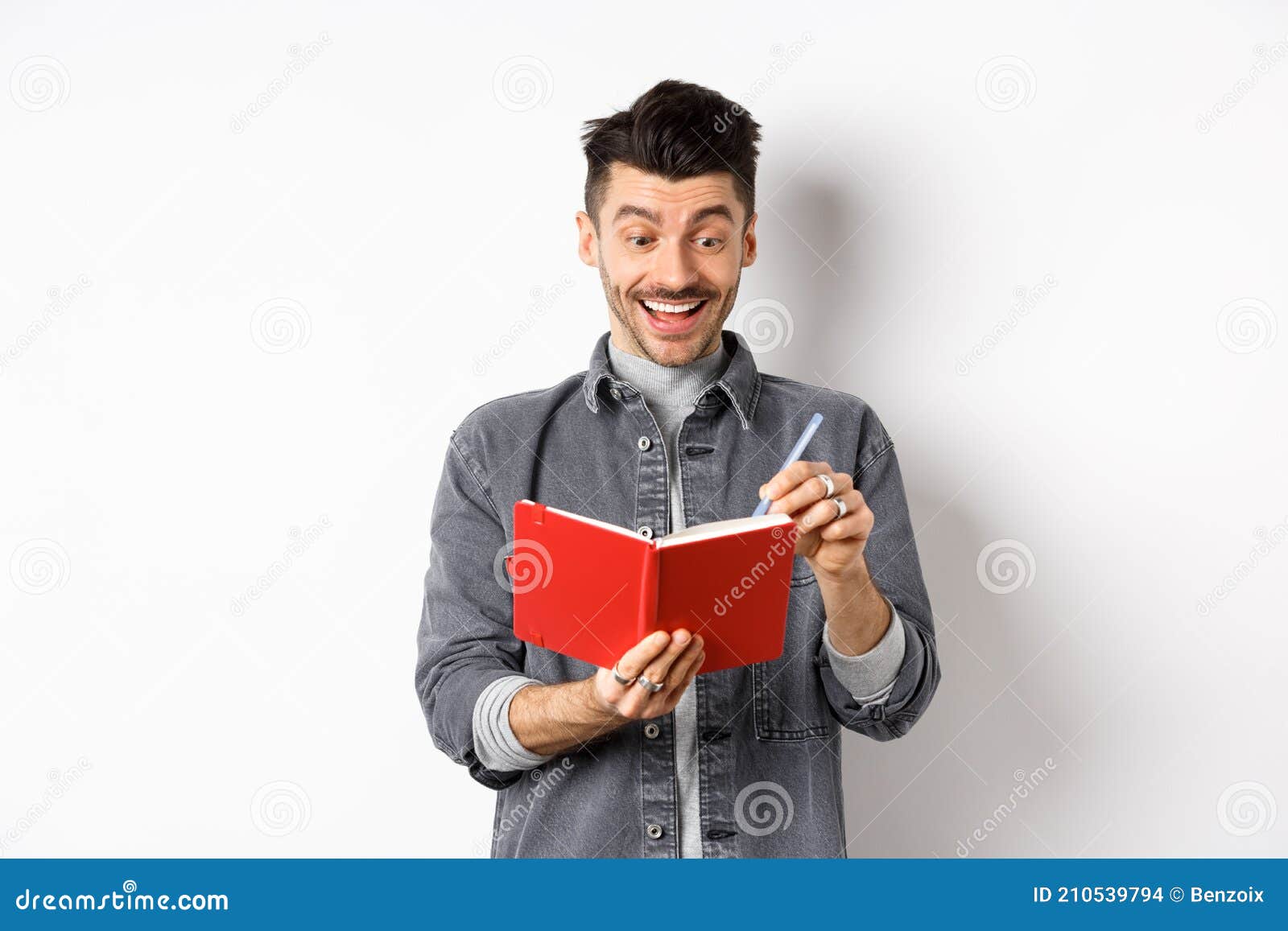 Excited Guy Writing in Planner and Smiling, Writing Down Ideas in ...