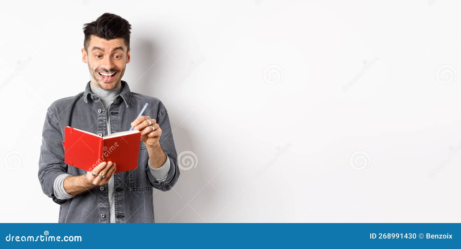 Excited Guy Writing in Planner and Smiling, Writing Down Ideas in ...