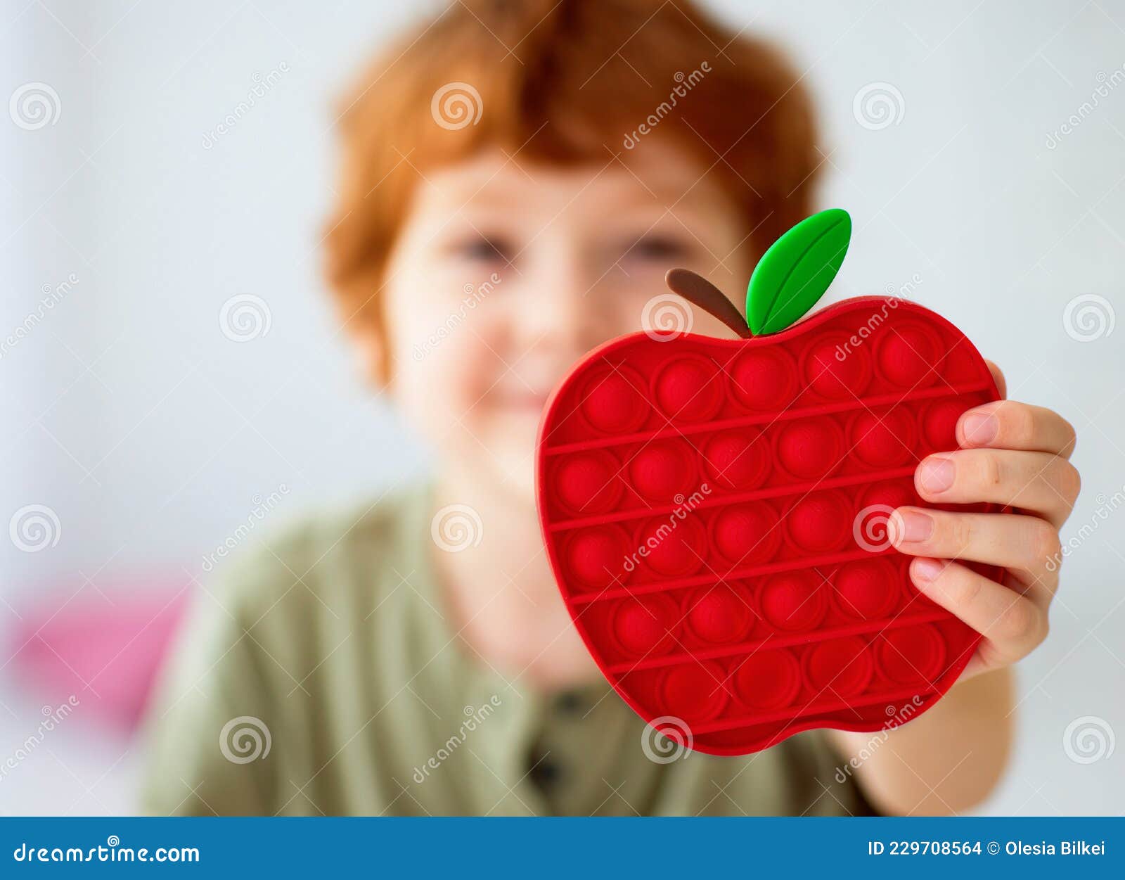 Excited Happy Kid Holding a Vibrant Sensory Toy, Pop it Fidget Toy in ...