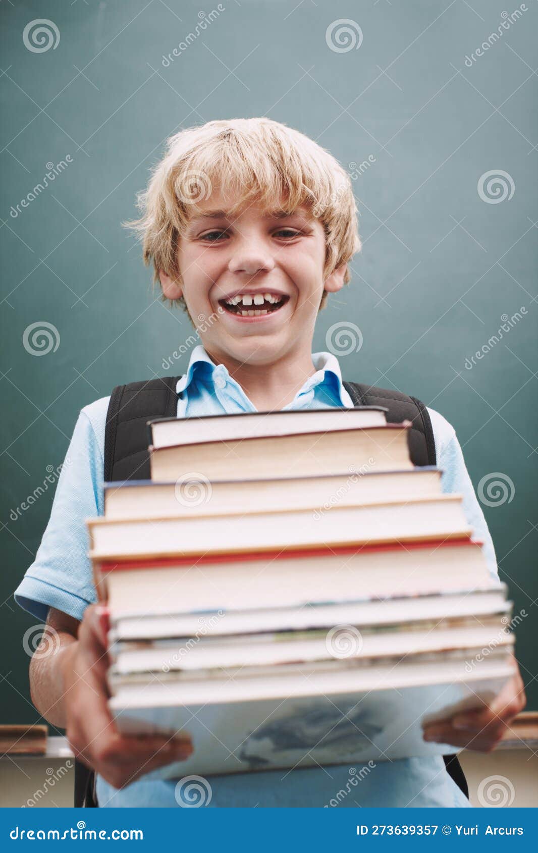Excited about Learning. an Eager Young Student Carrying a Tall Stack of ...