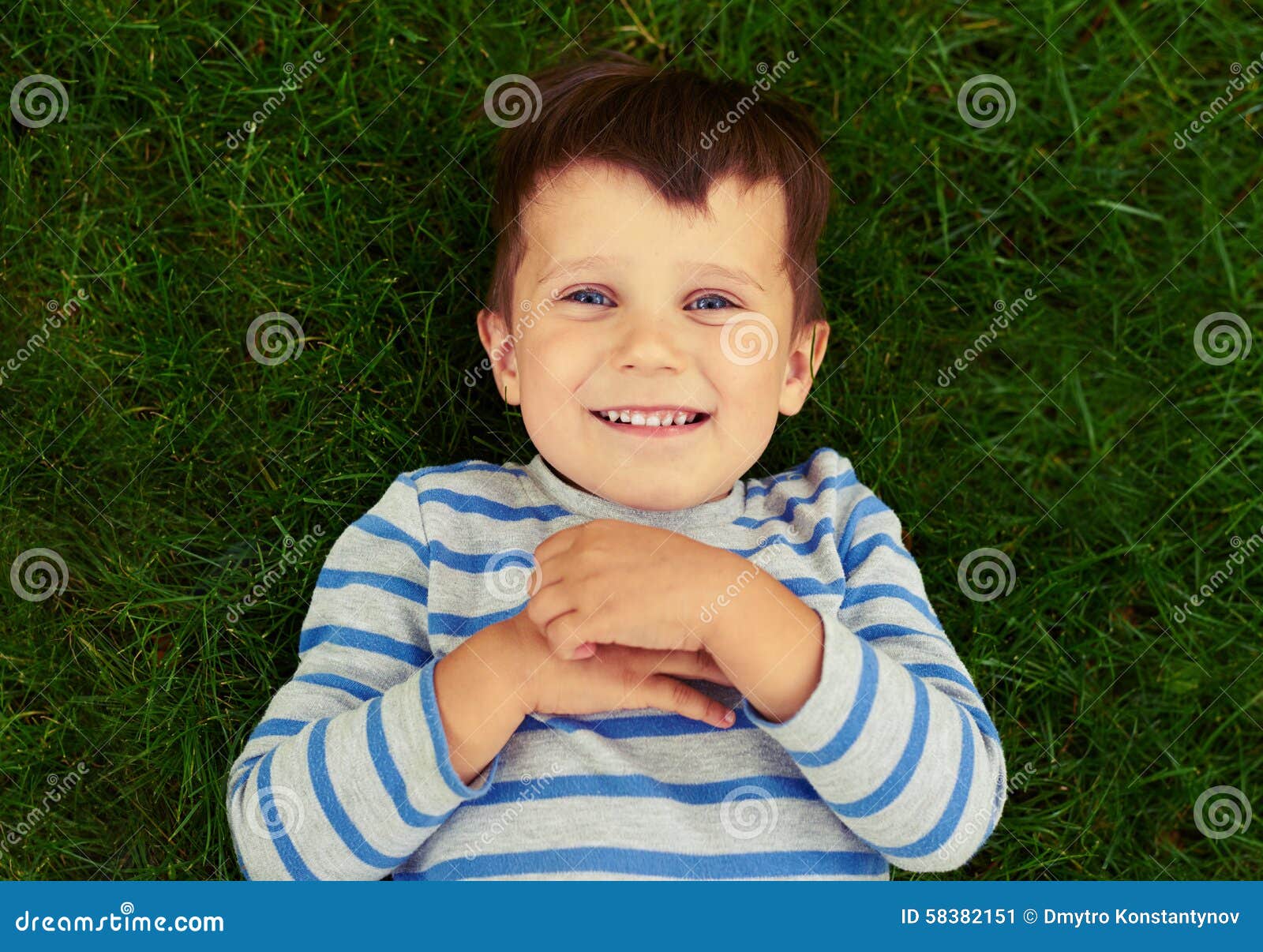 Excited Little Boy Lying on the Green Grass Stock Image - Image of ...
