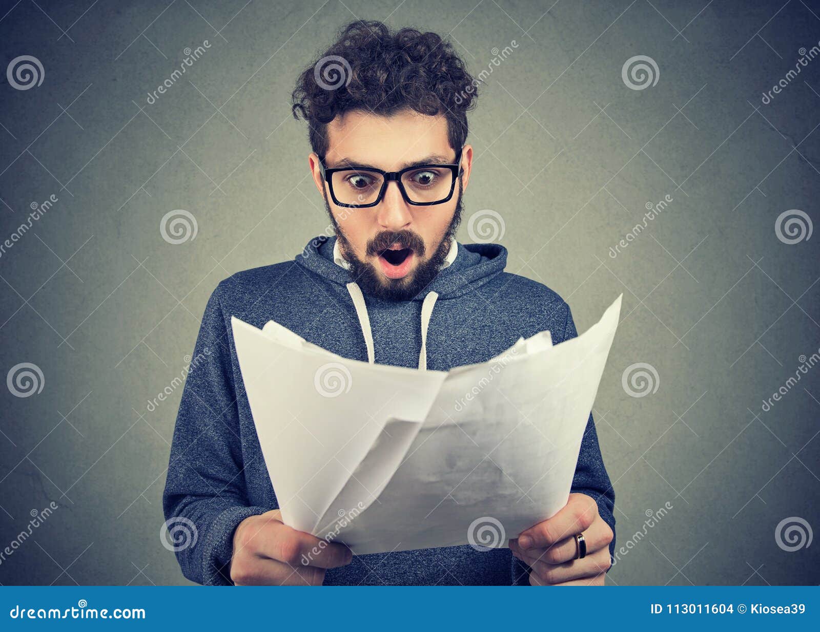 Excited Man Looking at Papers in Shock Stock Photo - Image of bills ...