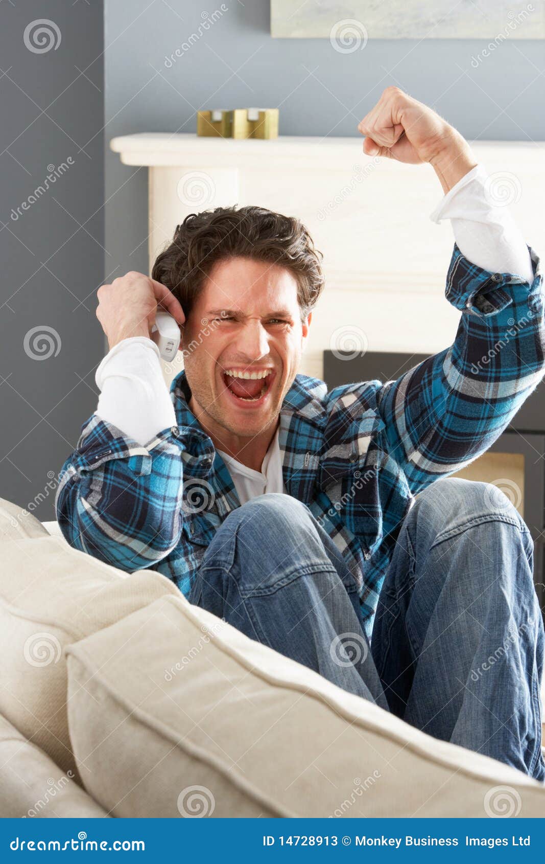 Excited Man Sitting on Sofa at Home on Phone Stock Image - Image of ...