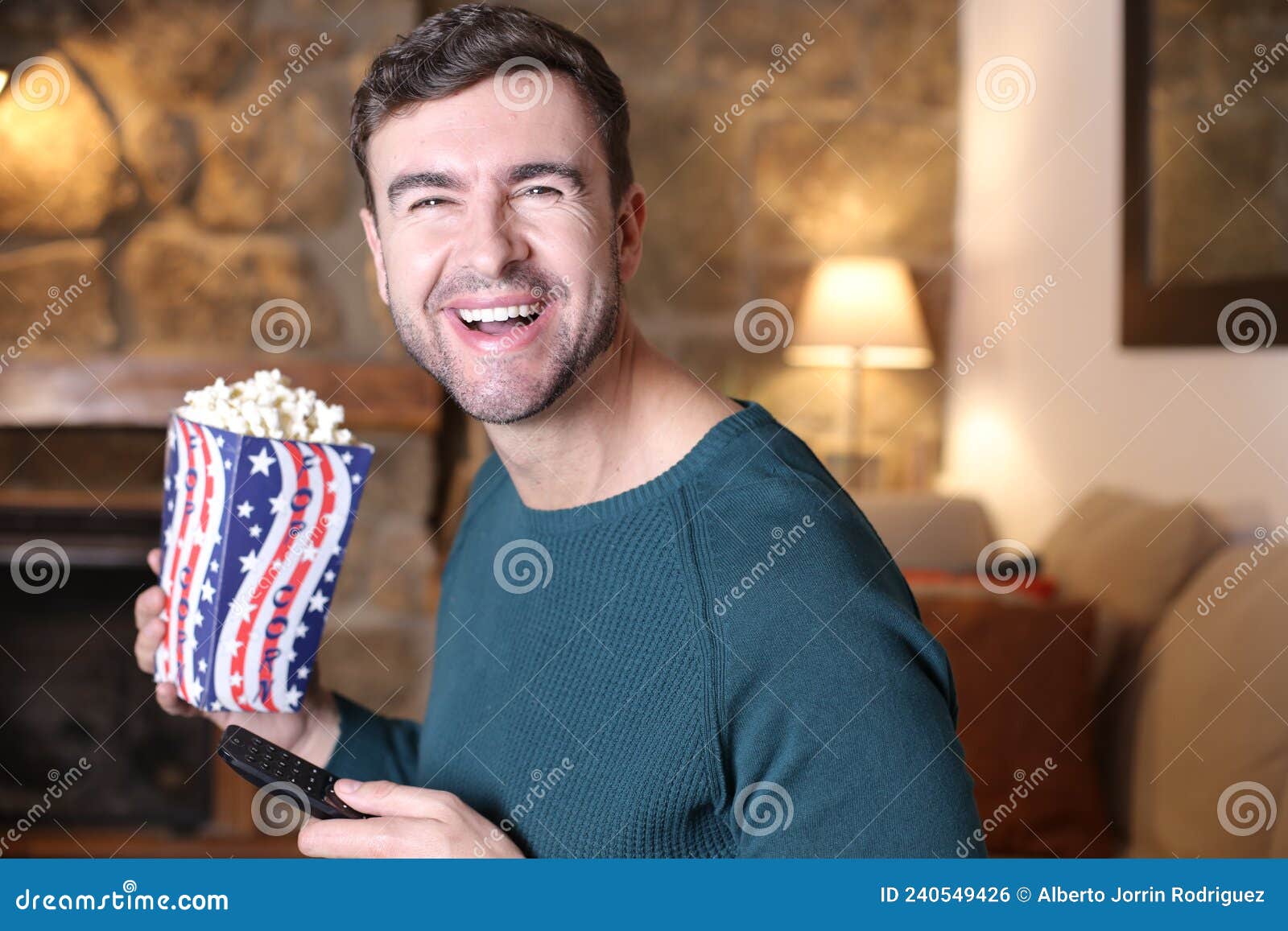 Excited Man Switching Channels and Eating Popcorn Stock Photo - Image ...