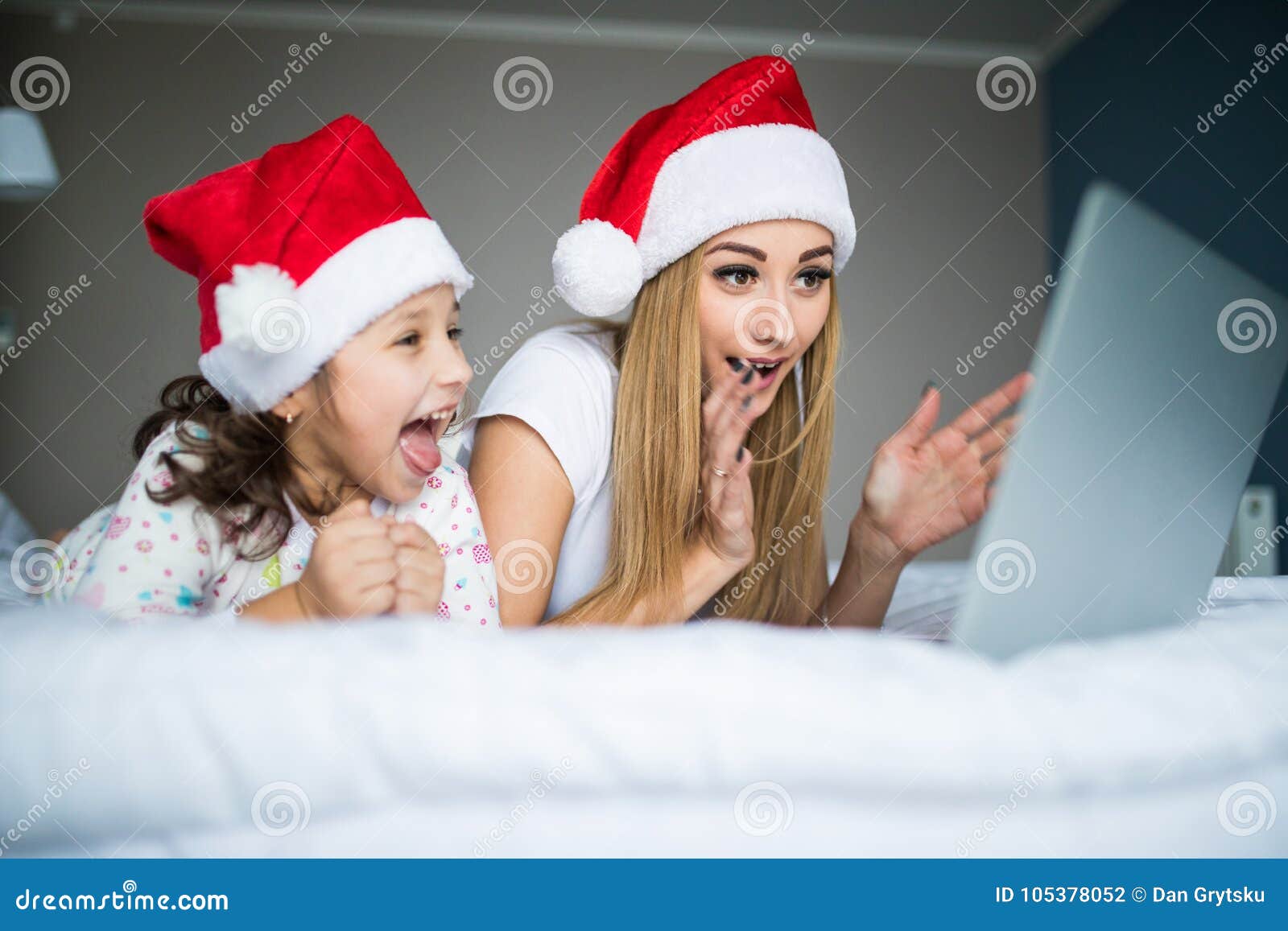 Excited And Surprise Mother And Daughter On Christmas Morning Using