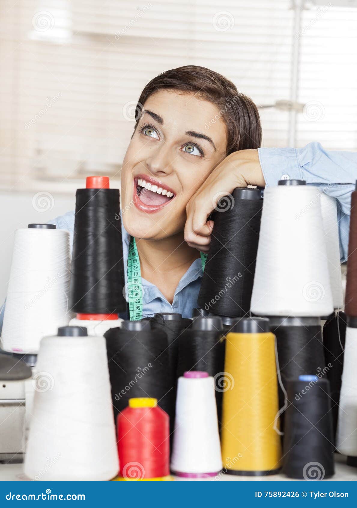 Excited Tailor Leaning on Stacked Thread Spools Stock Photo - Image of ...