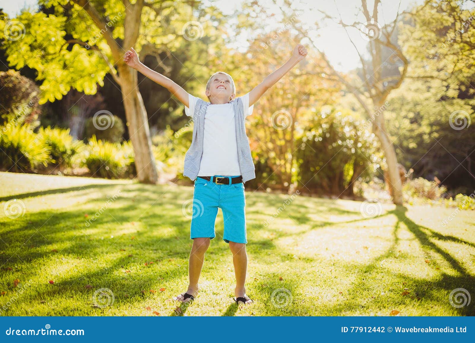 Excited young boy in park stock photo. Image of nature - 77912442