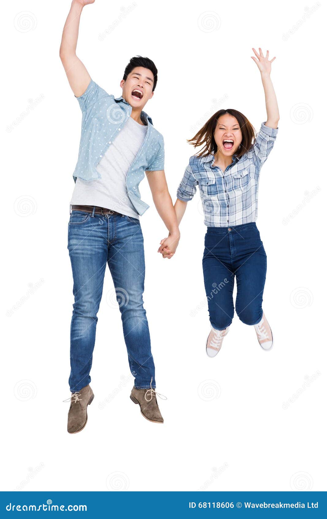 Excited Young Couple Holding Hands and Jumping Stock Photo - Image of ...