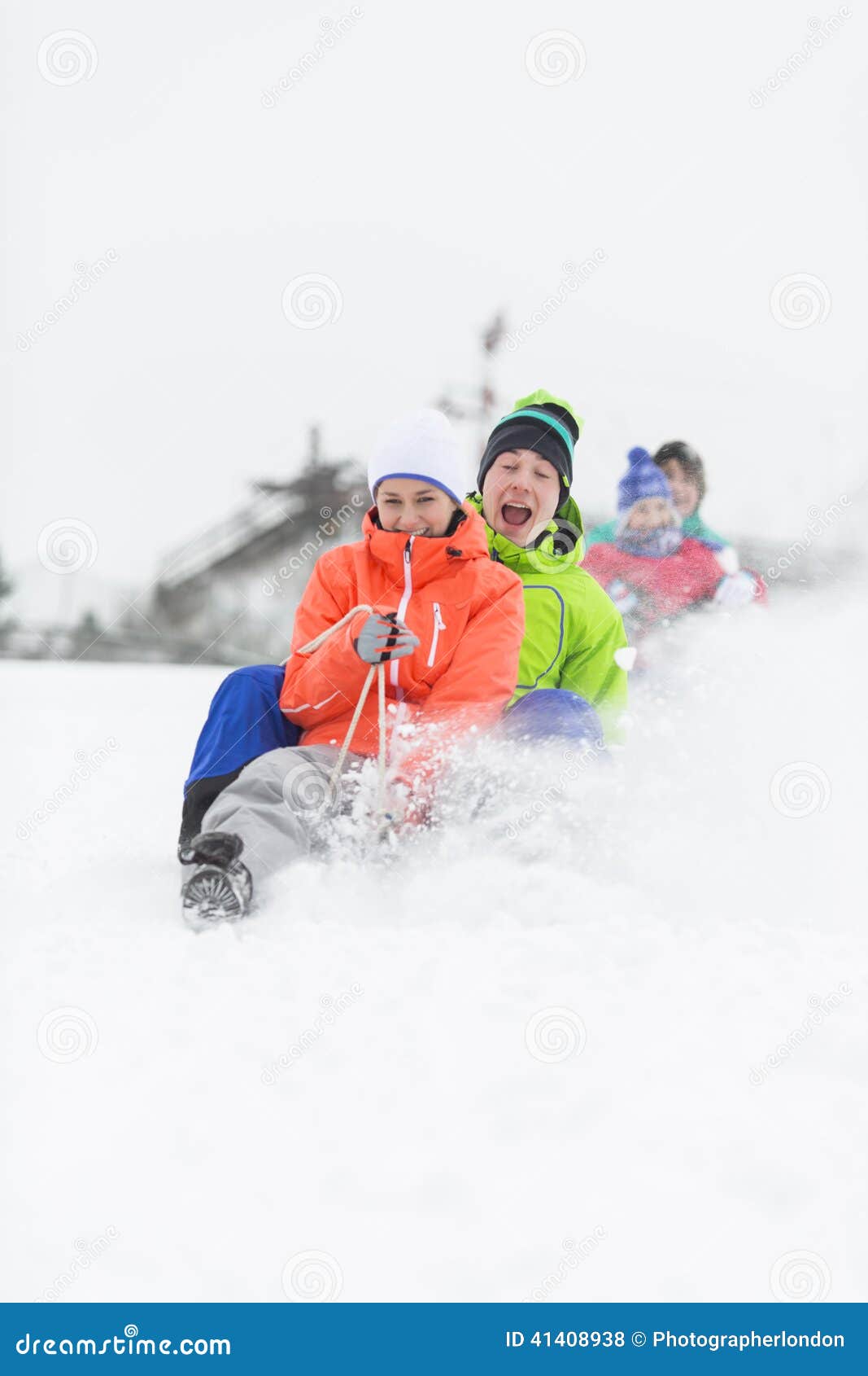 Excited Young Friends Sledding in Snow Stock Photo - Image of ...