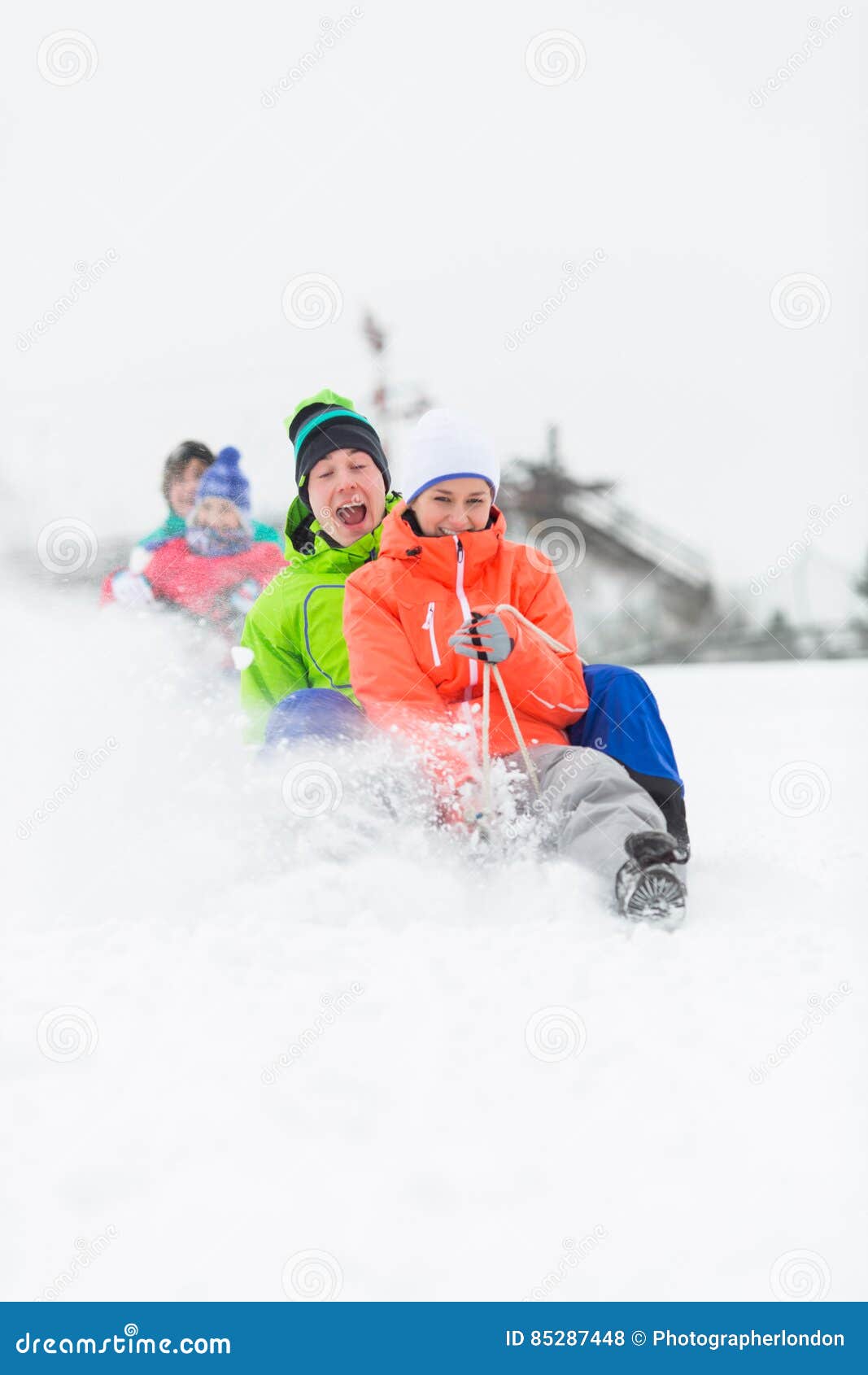 Excited Young Friends Sledding in Snow Stock Photo - Image of leisure ...
