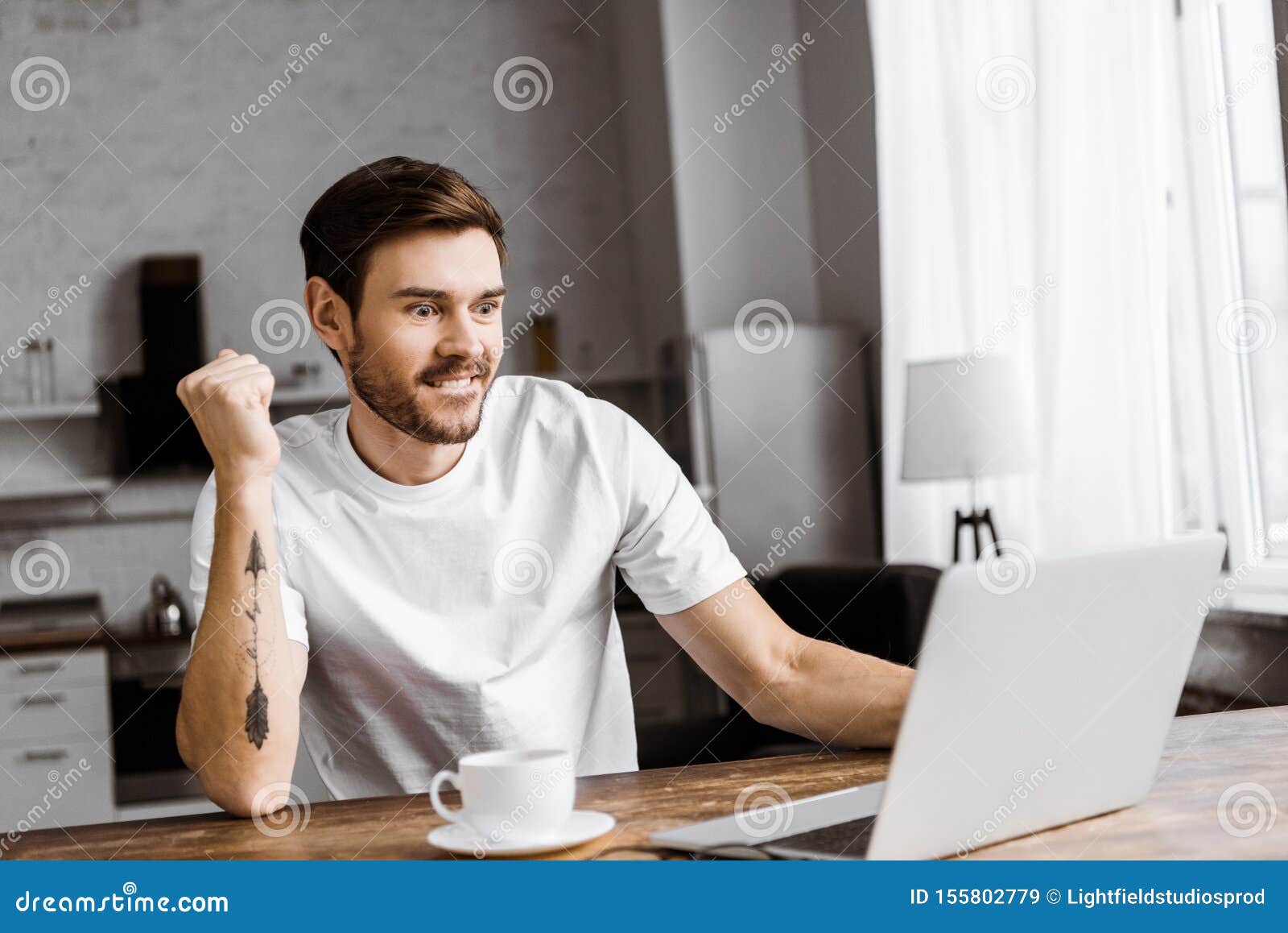Excited Young Man with Coffee Using Laptop Stock Image - Image of ...