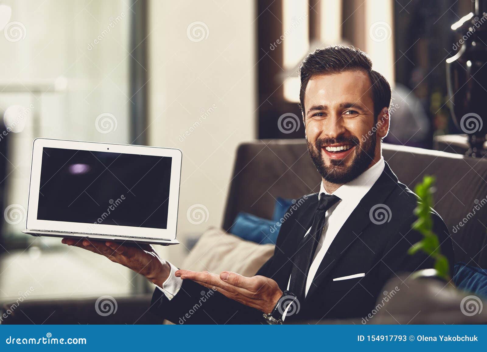 Excited Young Man Smiling while Demonstrating His Laptop Stock Image ... Excited Young Man Smiling while Demonstrating His Laptop Stock Image ...