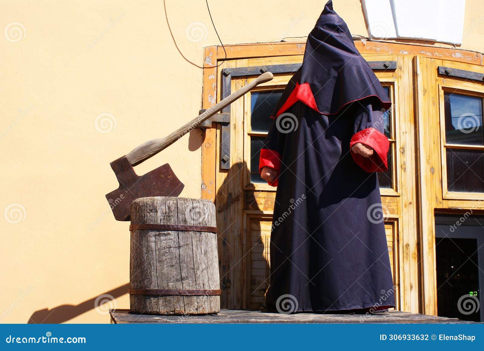 An Executioner in a Black Cloak and Mask on the Scaffold with an Ax ...