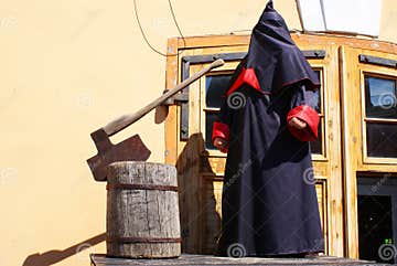 An Executioner in a Black Cloak and Mask on the Scaffold with an Ax ...