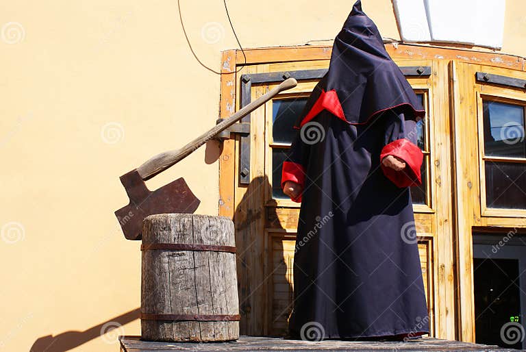 An Executioner in a Black Cloak and Mask on the Scaffold with an Ax ...