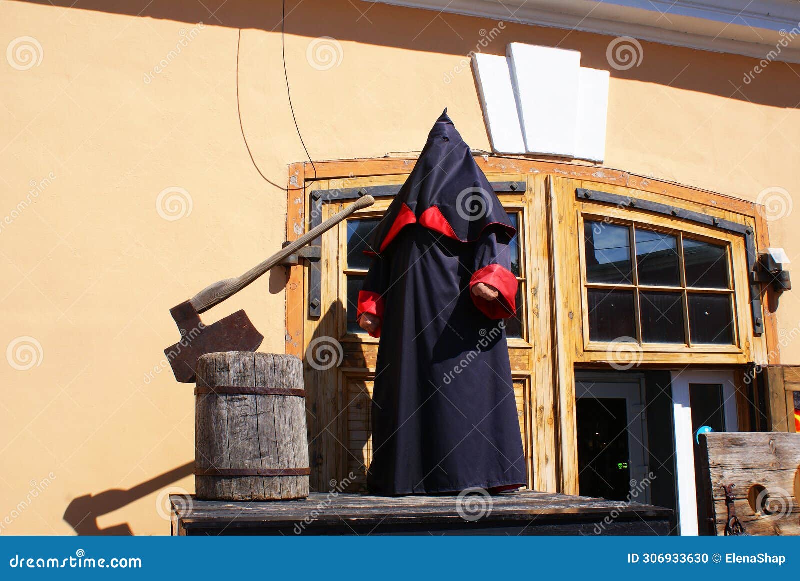 An Executioner in a Black Cloak and Mask on the Scaffold with an Ax ...