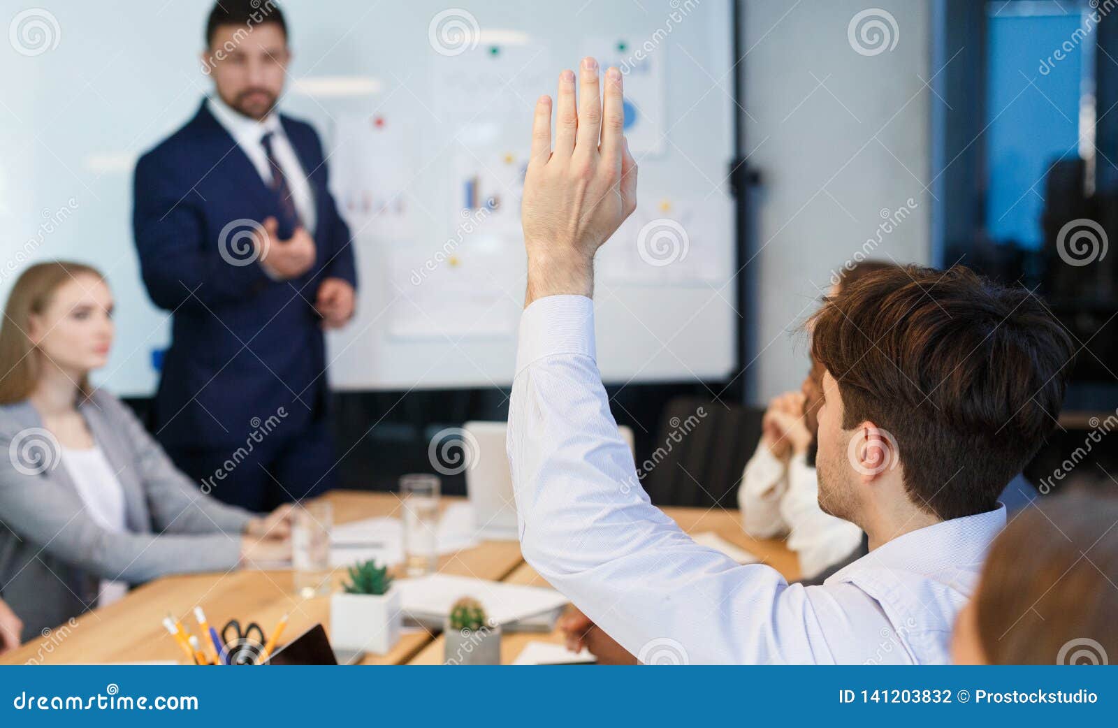 Executive Asking Question To Speaker at Presentation Stock Photo ...