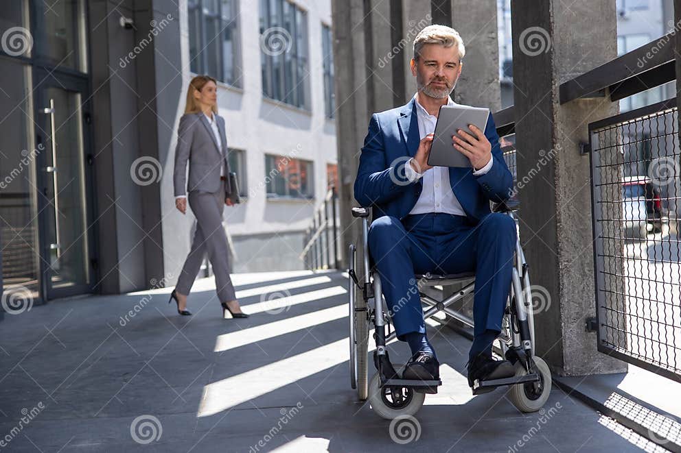 Executive Business Man in Wheelchair with Tablet Using Mobile Device ...