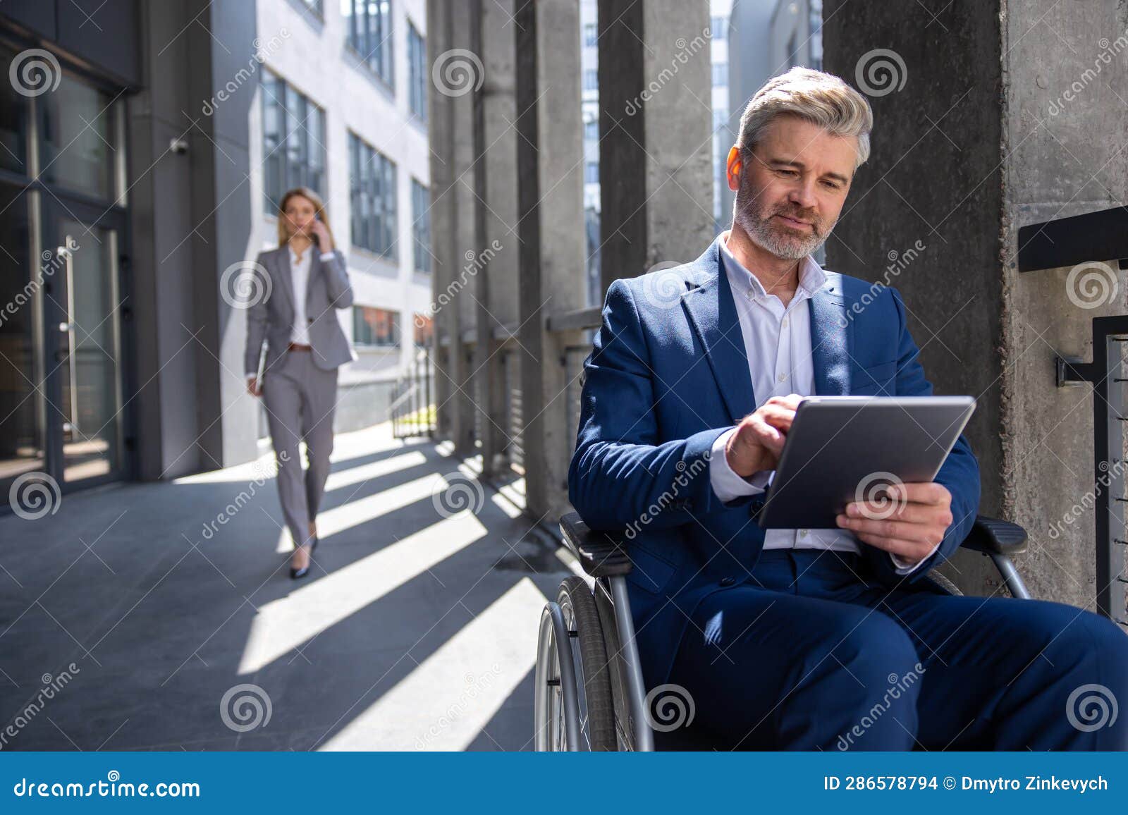 Executive Business Man in Wheelchair with Tablet Using Mobile Device ...