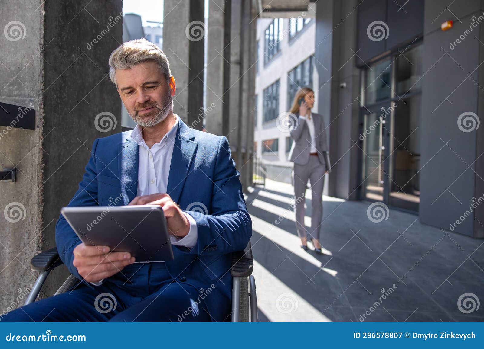 Executive Business Man in Wheelchair with Tablet Using Mobile Device ...