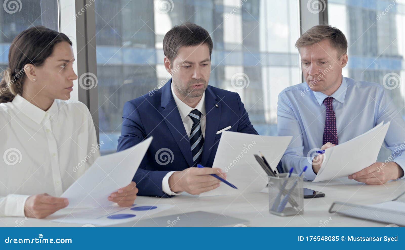 Executive Business People Sharing Information through Documents on ...