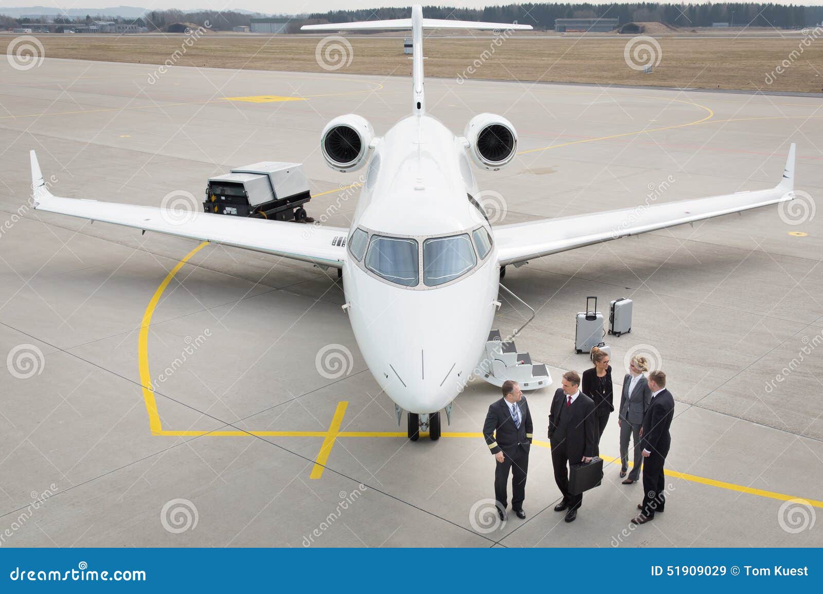 Executive Business Team in Front of Corporate Jet Talking To Pil Stock ...