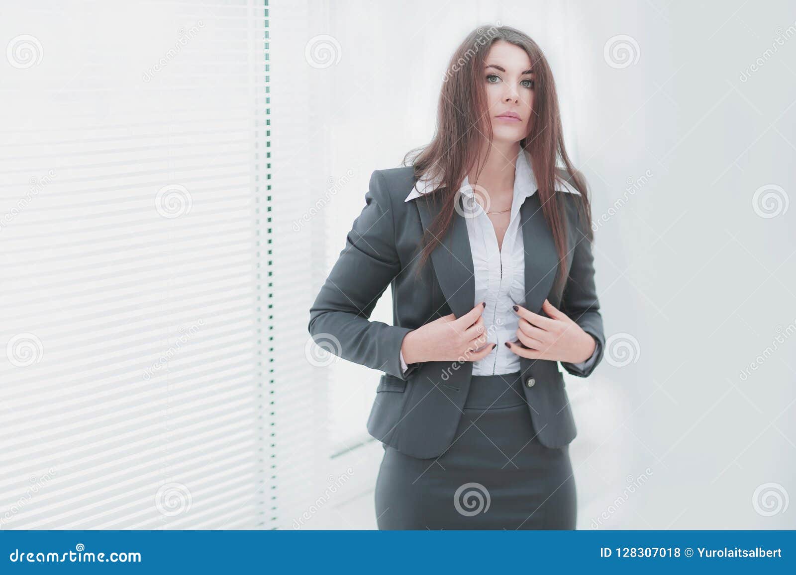 Executive Business Woman Standing Near Window In Spacious Office Stock