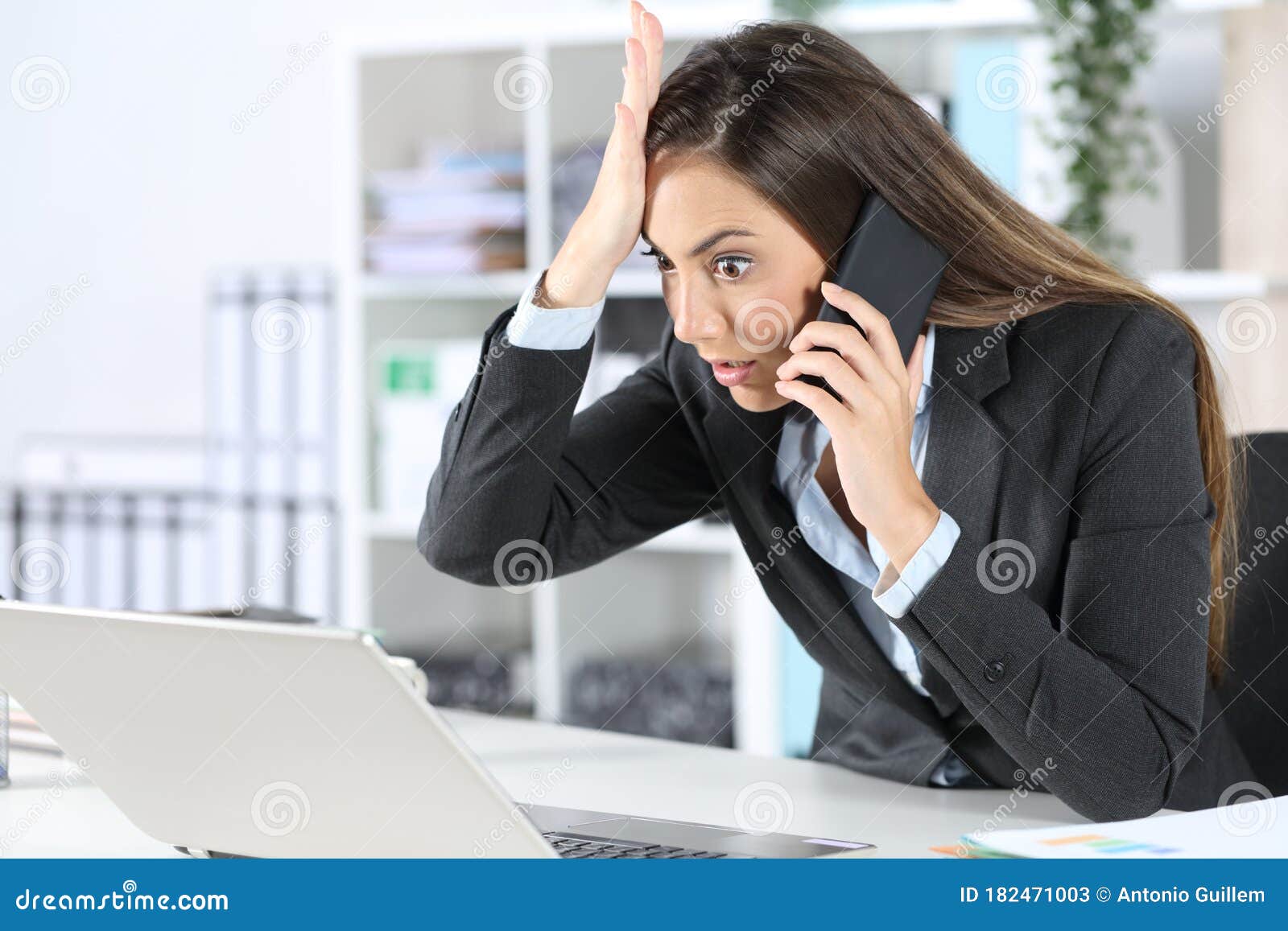 Executive Calling on Phone Discovers Mistake on Laptop at Office Stock ...