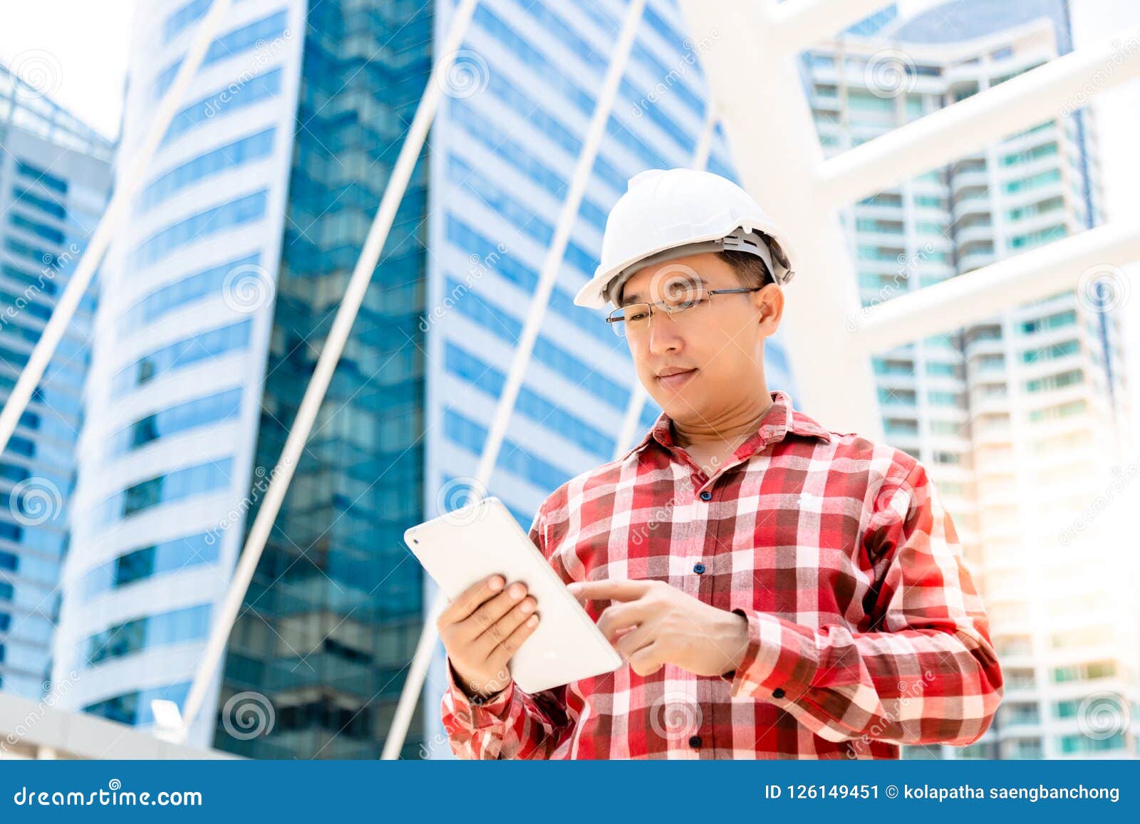 Executive Engineer Guy is Using Tablet for Record His Work or Sc Stock ...