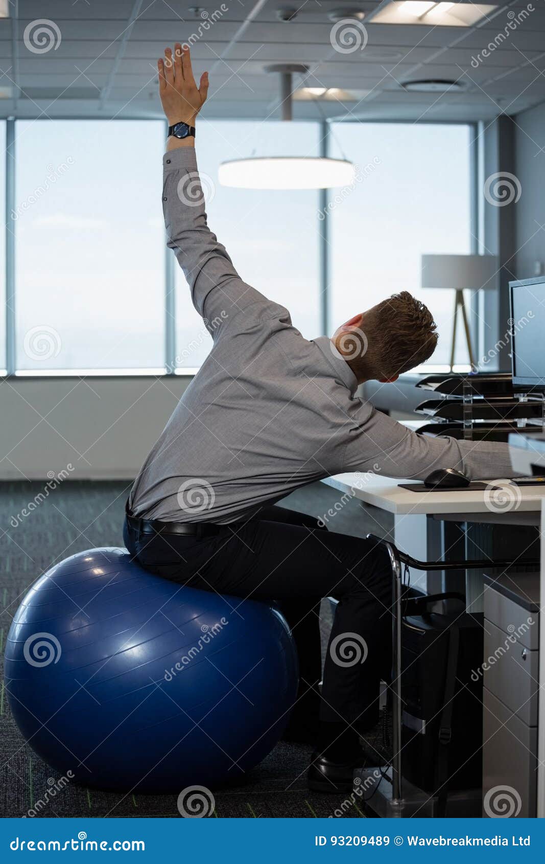 Executive Performing Stretching Exercise on Fitness Ball Stock Image ...