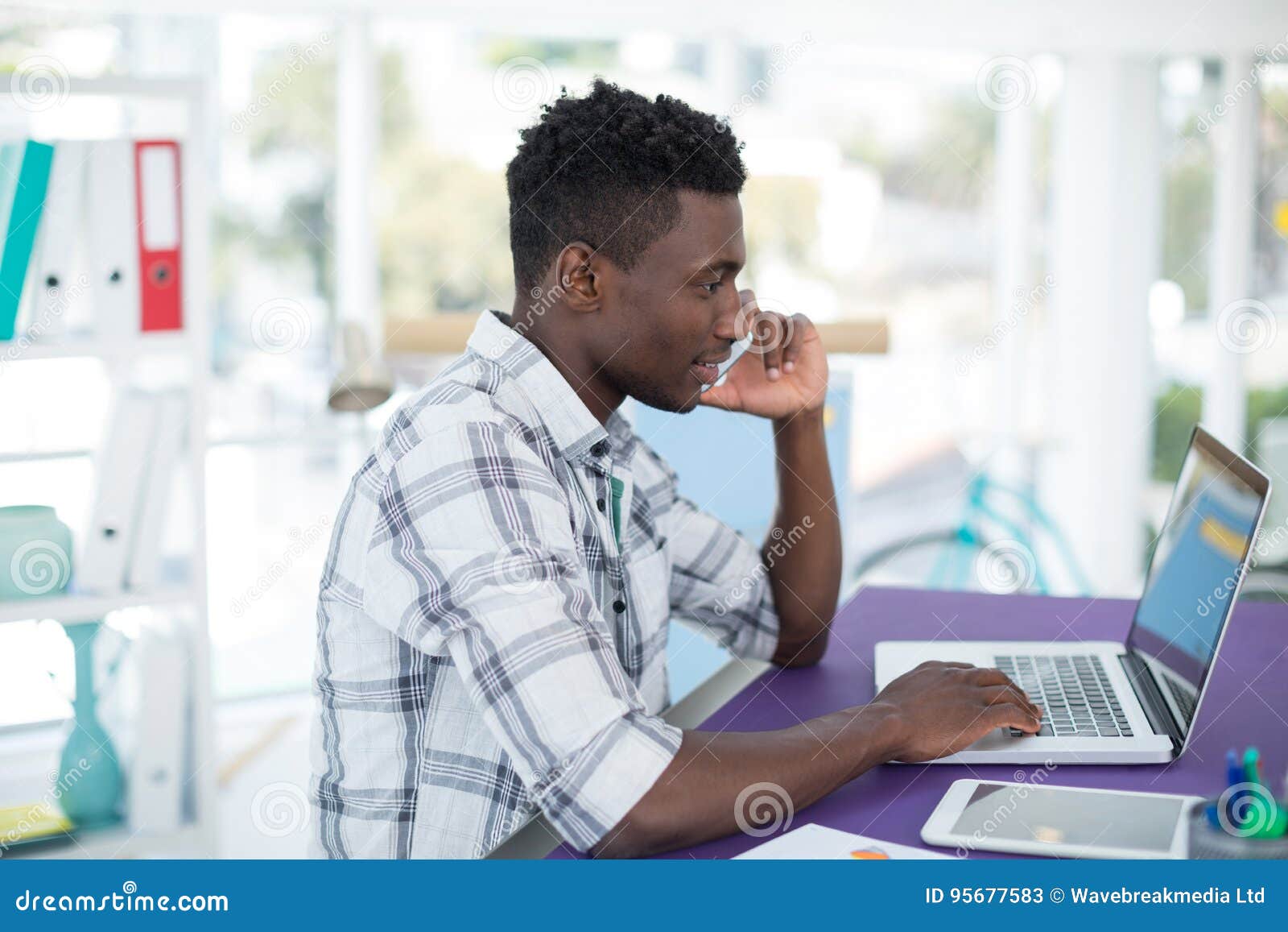 Executive Talking on Mobile Phone while Using Laptop in Office Stock ...