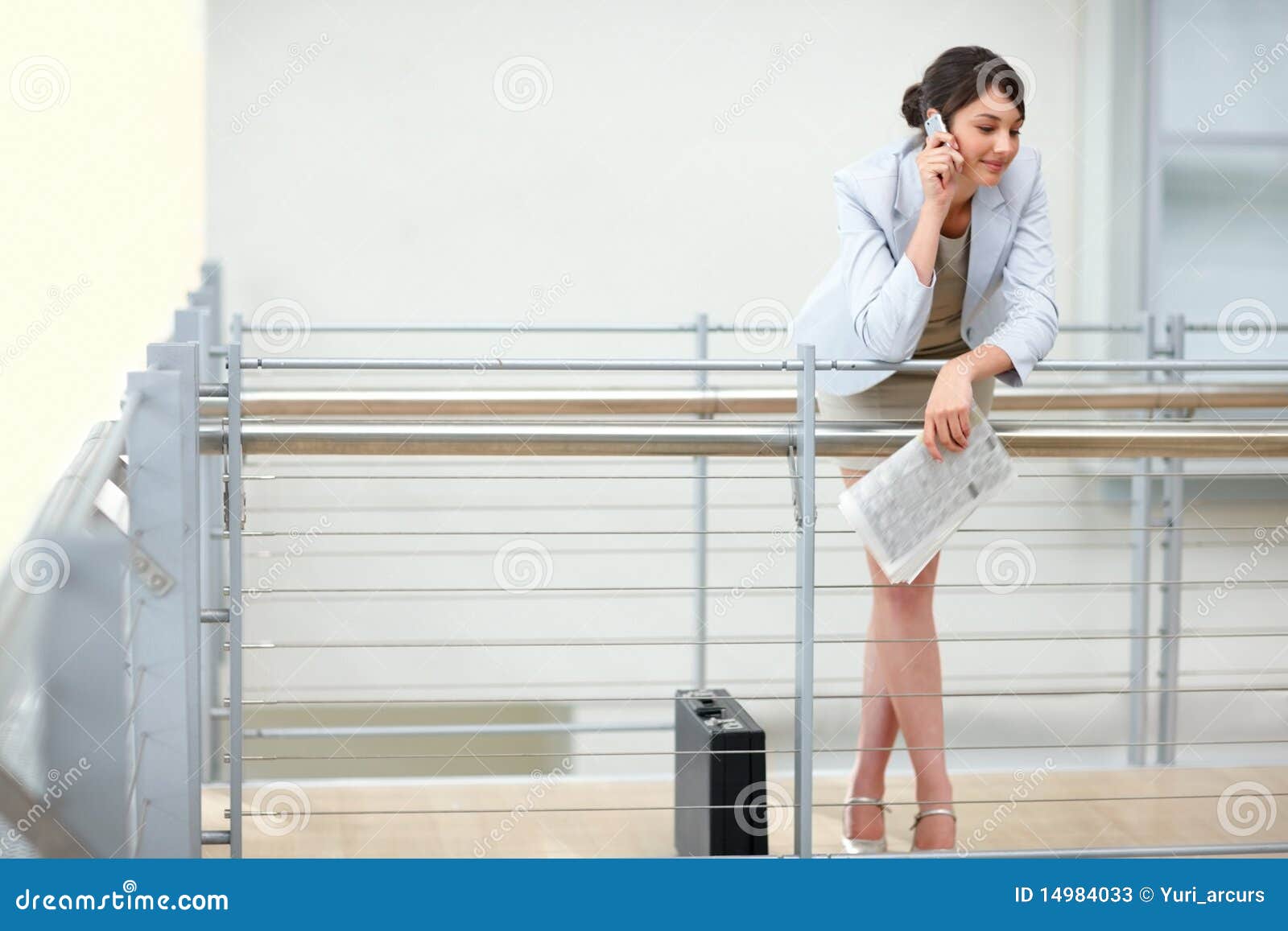 Executive Using Cellphone by a Railing at Office Stock Image - Image of ...