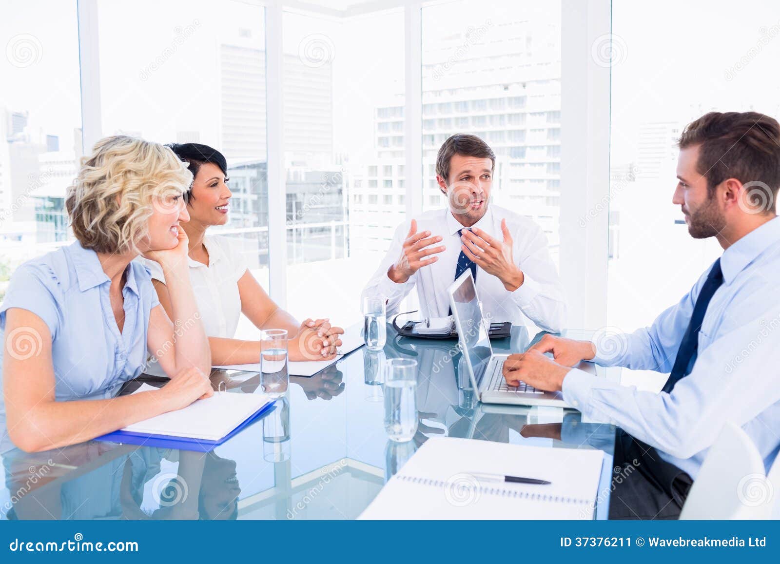 Executives Sitting Around Conference Table Stock Image - Image of ...